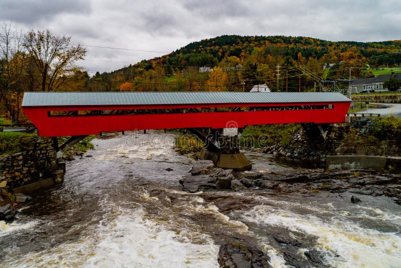A Red Covered Bridge First Built in 1883 Spans a Rapidly Flowing Stock ...