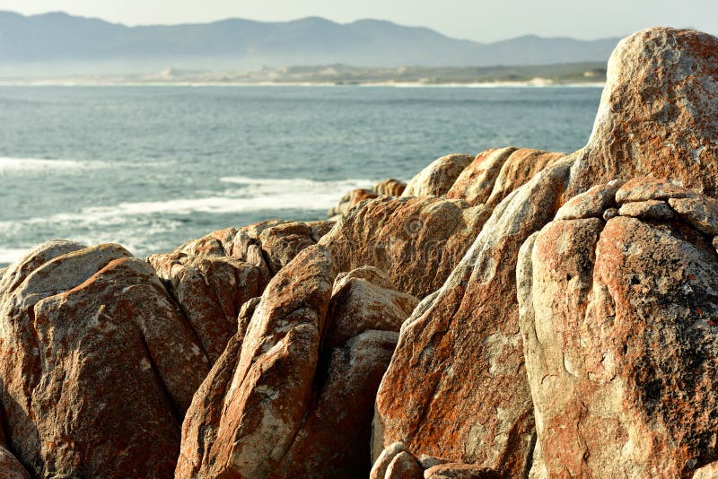 Red and Cream Colored Seaside Rocks Looking Like Sculptures Stock Image ...