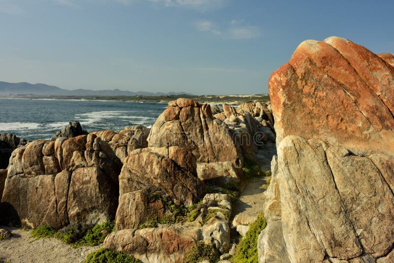 Red and Cream Colored Seaside Rocks Stock Photo - Image of scenery ...