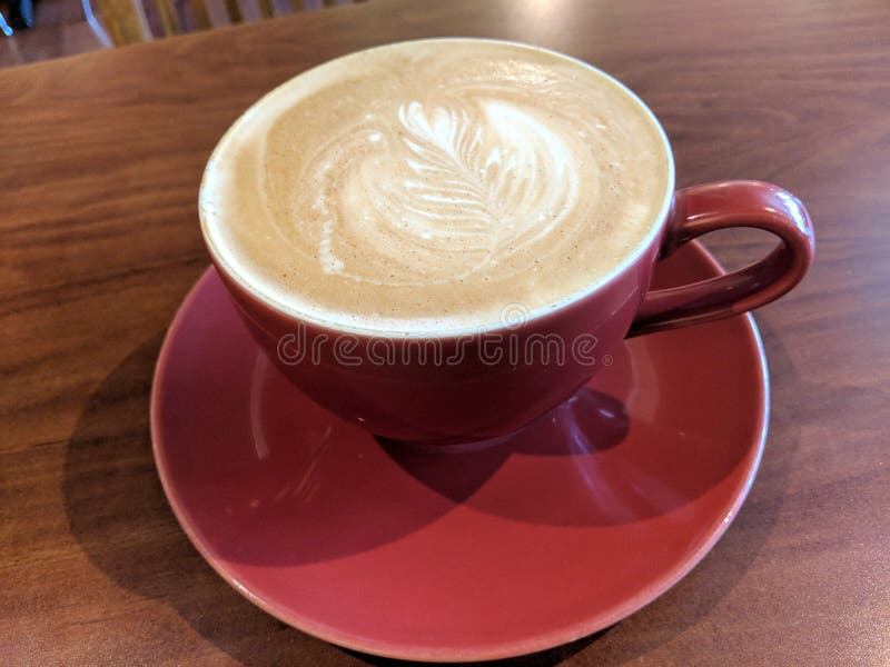 Red Cup of Cappuccino on Saucer with a Leaf Pattern in Foam Stock Photo ...