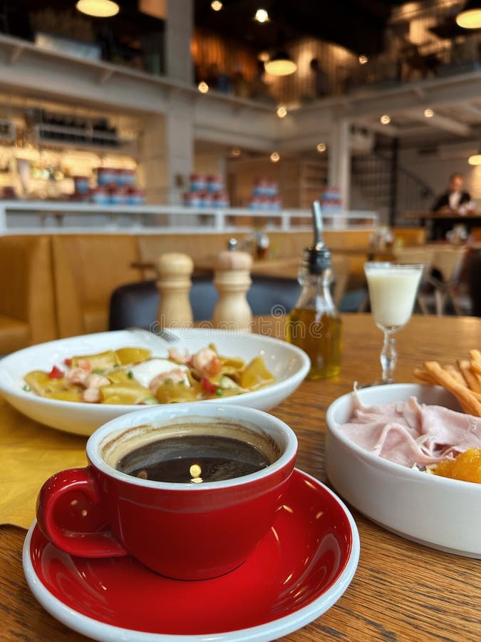 Red Cup of Coffee in Front of Dishes on the Table Stock Photo - Image ...