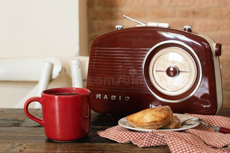 A Red Cup of Coffee, Pastry and a Radio are on the Kitchen Table. Stock ...