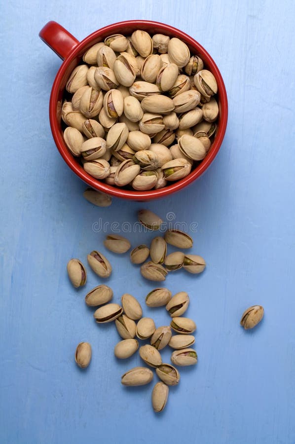 Red Cup of Pistachios on Blue Background Stock Photo - Image of health ...
