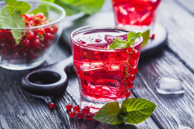 Red Currant Cocktail with Ice and Fresh Mint on a Black Wooden Table ...