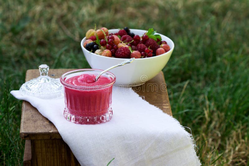 Red Currant Custard and a Plate with Berries on a Stool in the Garden ...