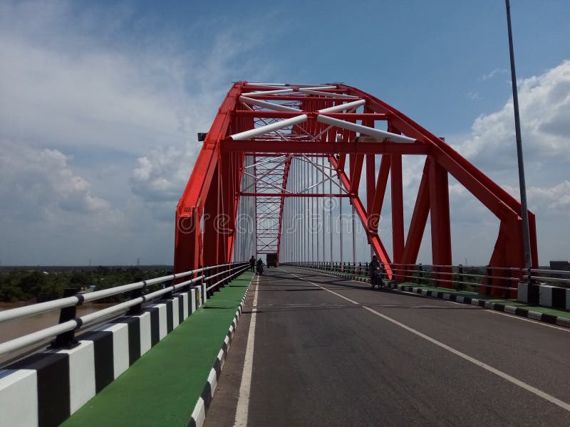 Red Curved Suspension Bridge Stock Image - Image of bridge, suspension ...