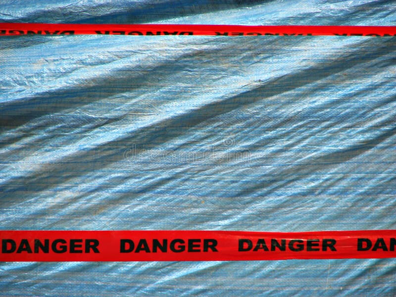 Red Danger Tape Over a Blue Wall Background Stock Image - Image of ...