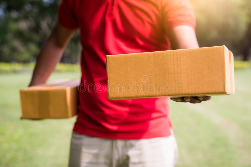 Red Delivery Man Holding Parcel Card Box. Stock Photo - Image of ...