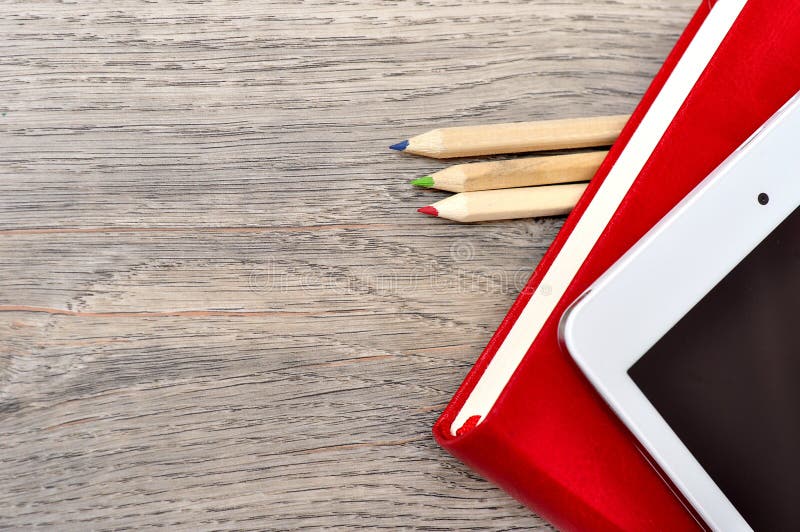 Red Diary Notebook, White Tablet and Colored Pencils on Desk Woo Stock ...
