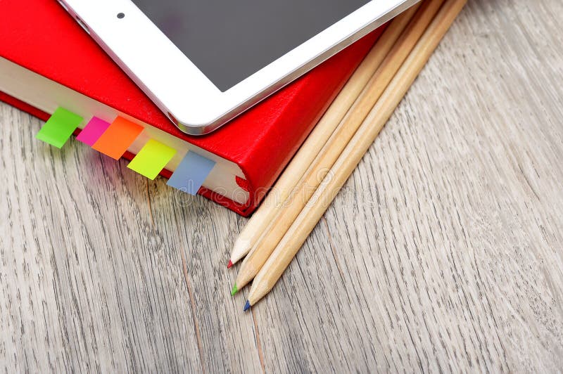 Red Diary Notebook, White Tablet and Colored Pencils on Desk Woo Stock ...