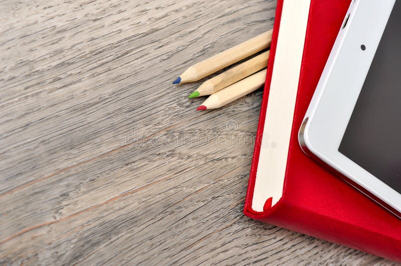 Red Diary Notebook, White Tablet and Colored Pencils on Desk Woo Stock ...