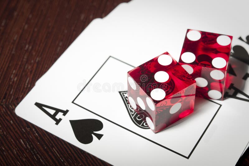 Red dice on spreaded cards stock image. Image of aces - 47025335