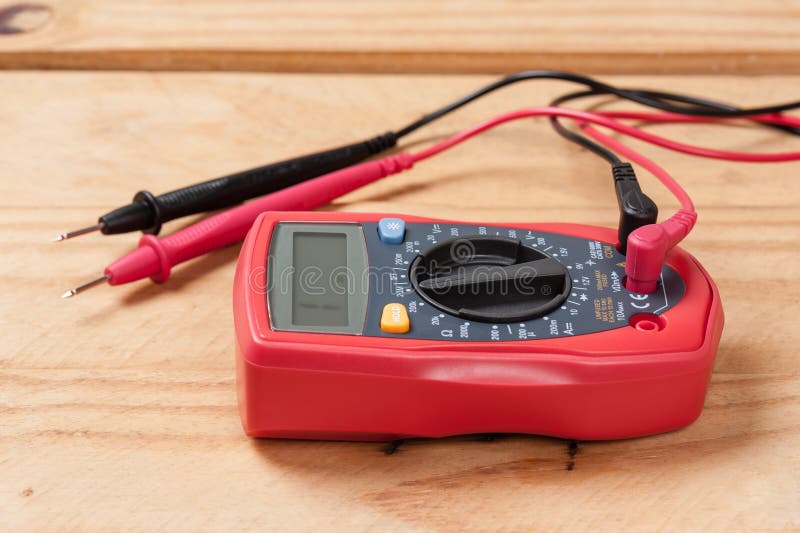 Red Multimeter or a Multitester, Also Known As a VOM on Gray Table ...