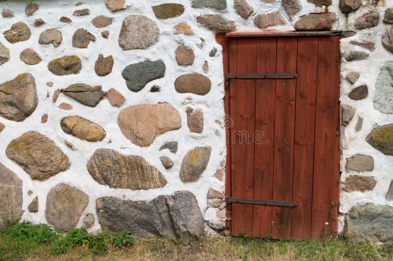 Stone Boulder Wall with Red Wooden Door Stock Photo - Image of farm ...