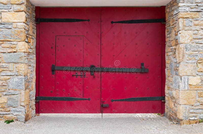 Red Doors Closed with Black Metal Bars in Stone Wall Stock Photo ...