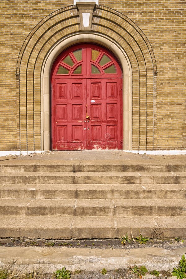 Red Double Doors with an Arched Top, Set into a Brick Building. Stock ...