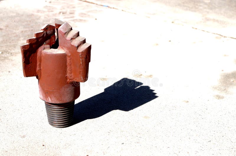 A Red Drill Bit or Rock Bit on Concrete. Stock Photo - Image of ...