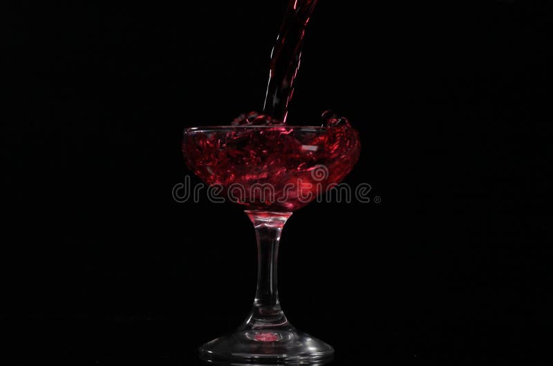 Red Drink Splash into the Glass with Black Background Stock Image ...