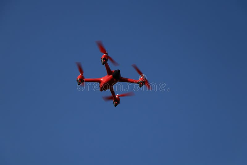 Red Drone on a Blue Background Stock Image - Image of blue, copter ...