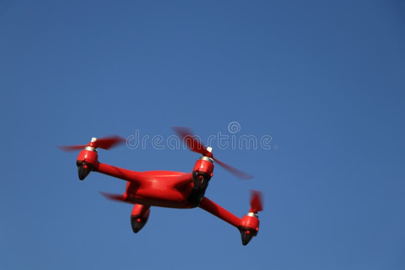 Red Drone on a Blue Sky Background Stock Image - Image of quadcopter ...