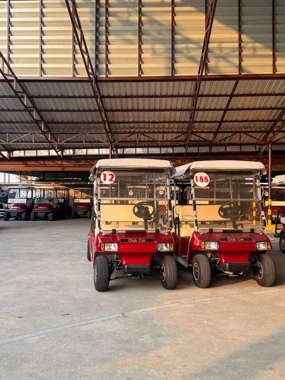 Red Electric Carts Wait for Use in a Spacious Storage Area during ...