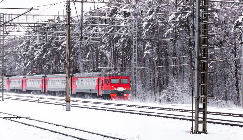 Red Electric Train Moves through Winter Forest Stock Photo - Image of ...