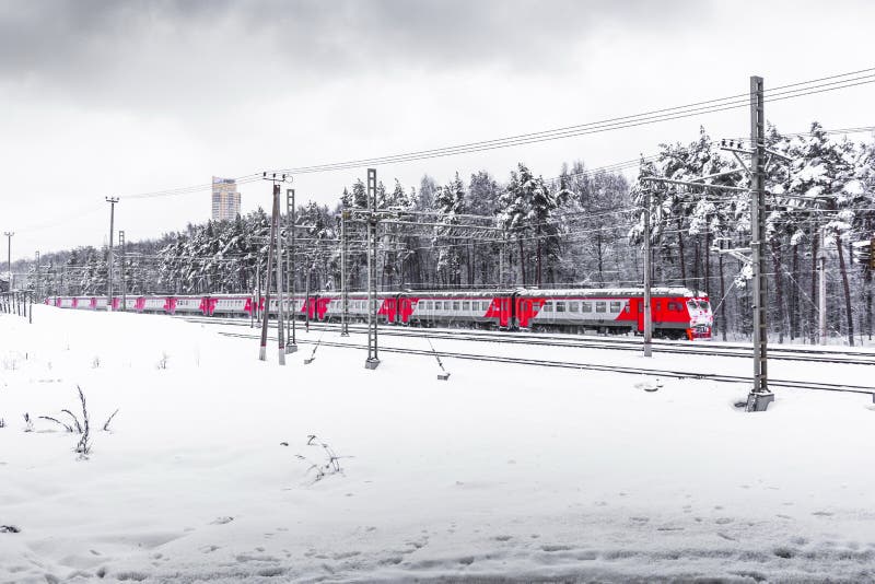 Red Electric Train Moves through Winter Forest Stock Image - Image of ...