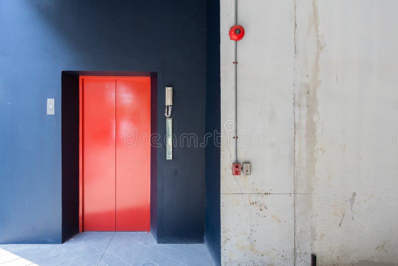 Red Elevator and Black Wall with Fire Alarm, Telephone Stock Image ...