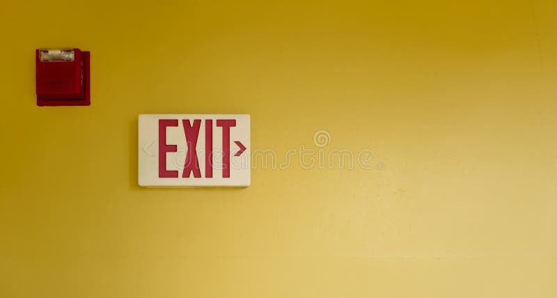 Emergency Exit Sign Isolated on a Bright Yellow Wall Banner Backdrop ...