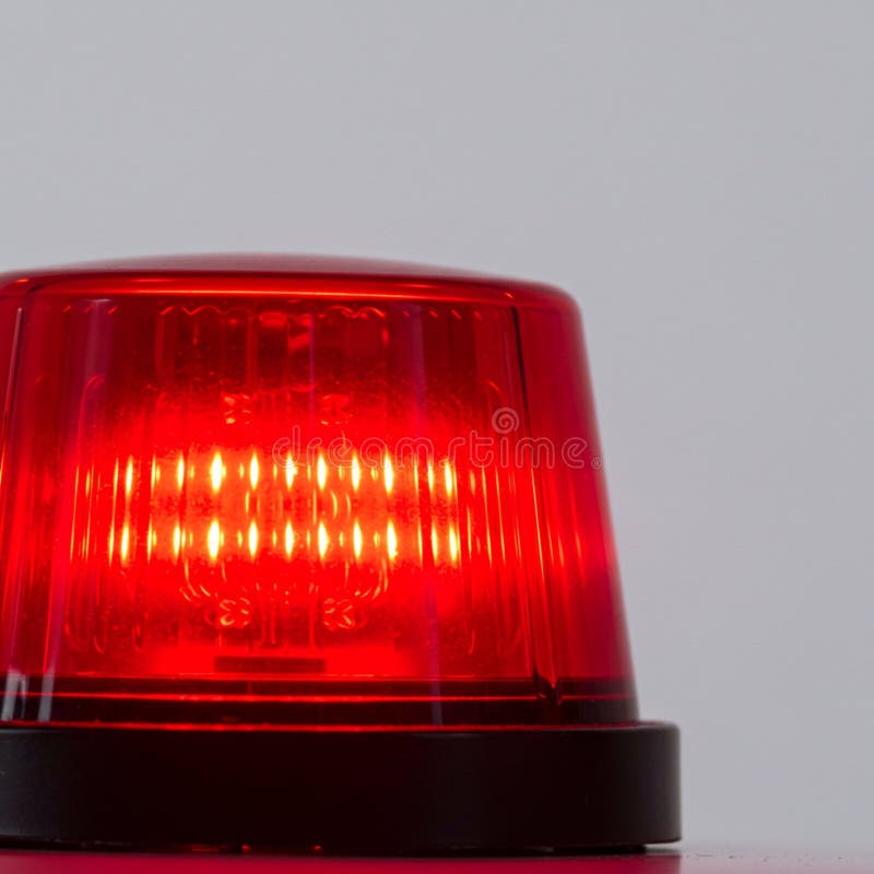 Red Emergency Siren Light with a Translucent Plastic Dome, Mounted on a ...