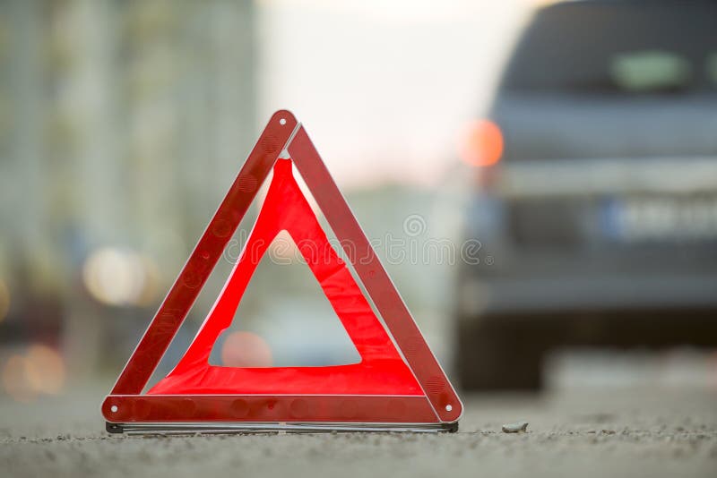 Red Emergency Triangle Stop Sign and Broken Car on a City Street Stock ...