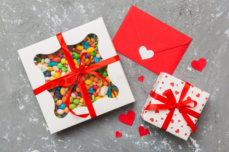 Red Envelope with Candy and Gift Box and Valentines Hearts on Colored ...