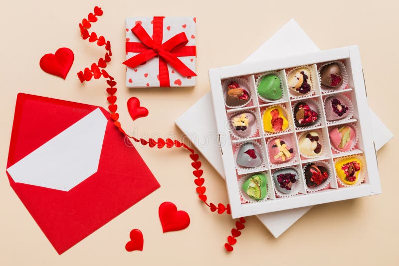 Red Envelope with Candy and Gift Box and Valentines Hearts on Colored ...