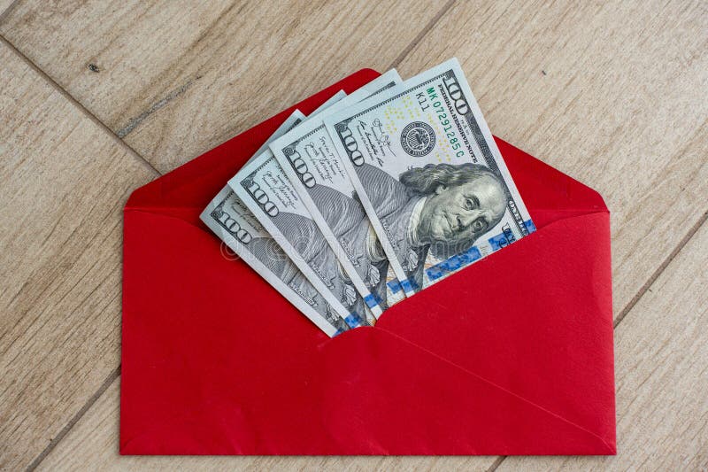 Red Envelope with Multiple 100 US Dollar Bills on Wooden Background ...