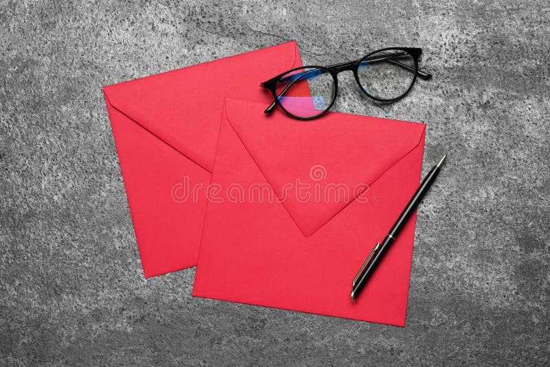 Red Envelopes, Glasses and Pen on Grey Table, Top View Stock Photo ...