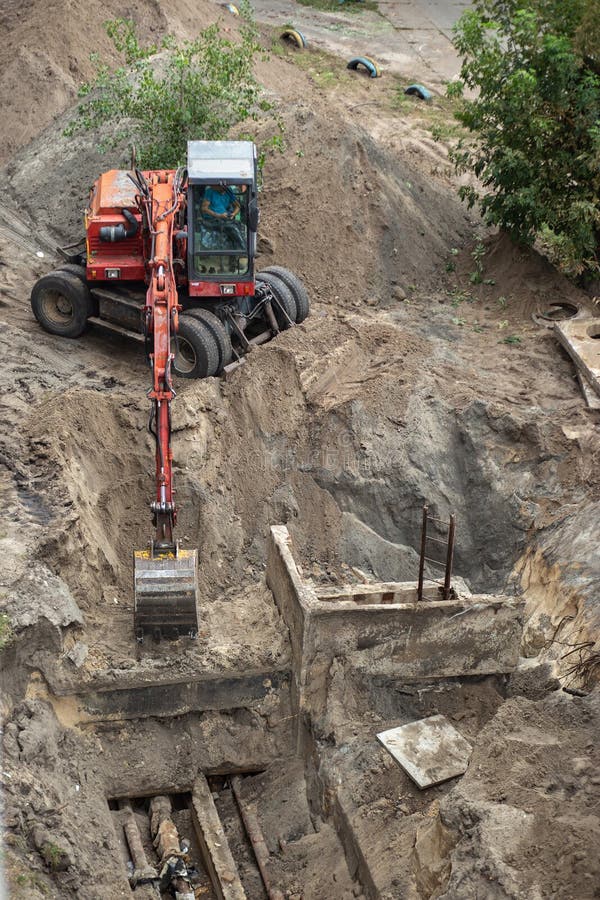 Red Excavator Digging a Pit Stock Photo - Image of loader, mover: 134935032