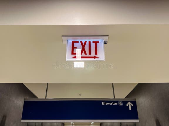 Red Exit Sign Above an Elevator Sign Stock Photo - Image of emergency ...