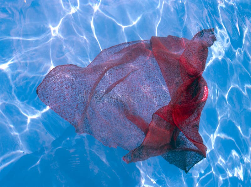 Red Fabric Floating in Pool Stock Image - Image of lookup, rainy: 112519861