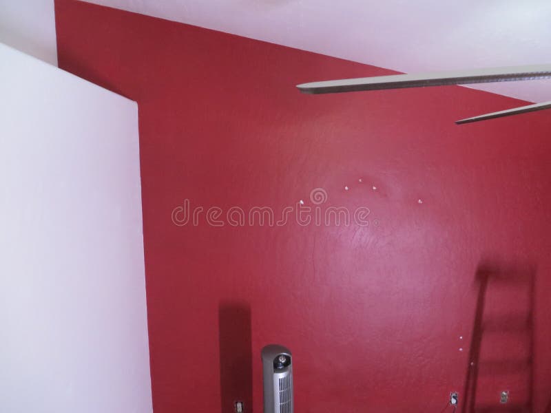Red Feature Wall with Angled Ceiling in Bedroom Being Remodeled Stock ...