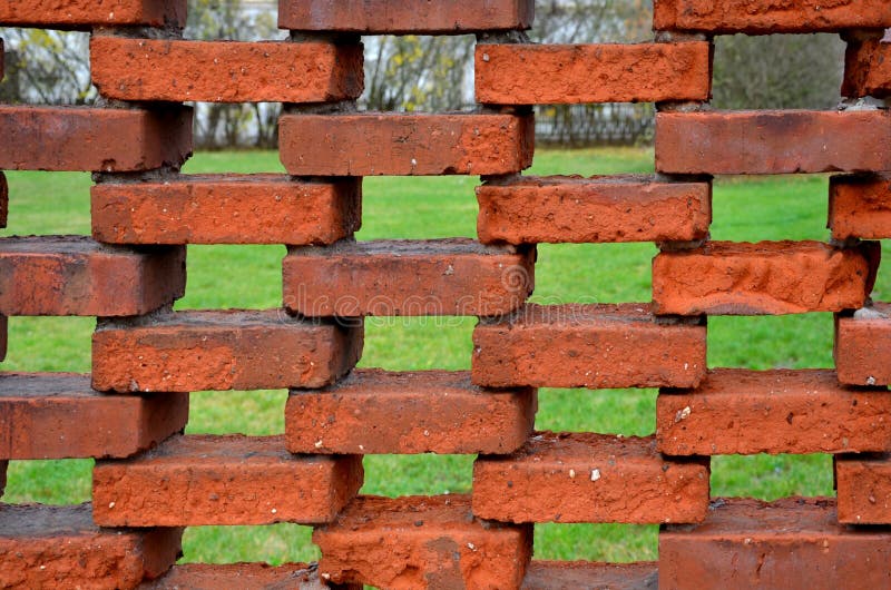 Red Fence Around the Garden Built of Burnt Clay Bricks with Large Gaps ...