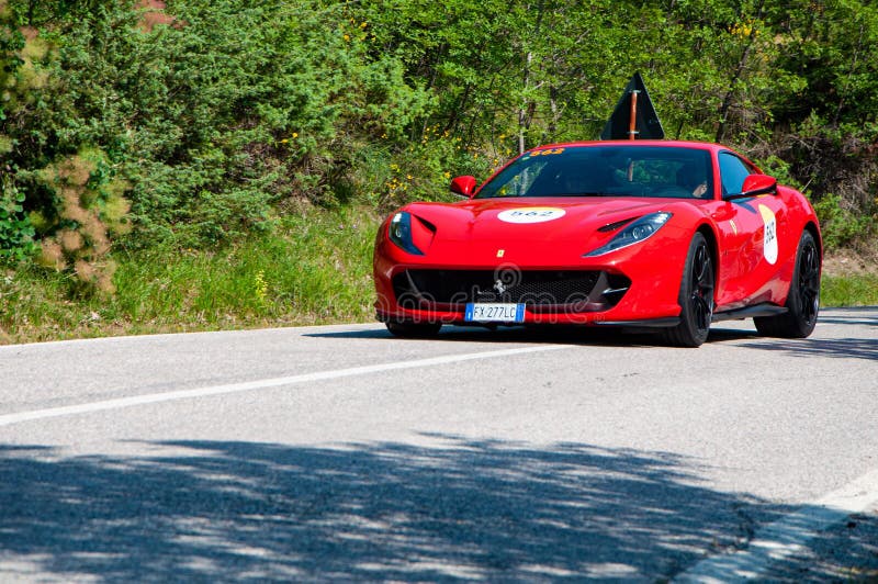 Red Ferrari 812 Superfast during the Mille Miglia 2022 with Trees in ...