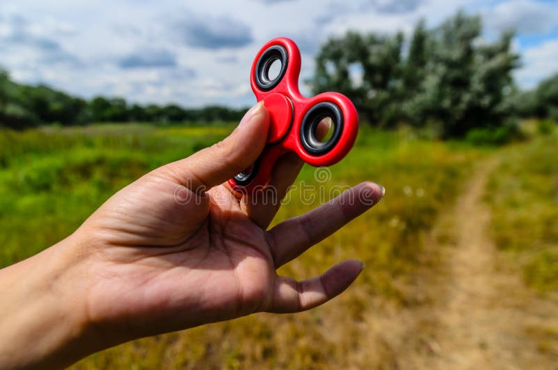 Red Fidget Spinner in Female Hand Stock Photo - Image of fashion ...