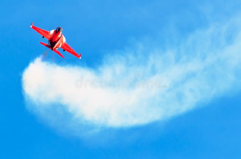 Red Fighter Jet in the Blue Sky with White Smoke Trail Stock Photo ...