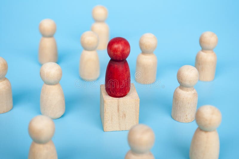Red Figure on Top of Wooden Cube Surrounded with Other Wooden Figure ...