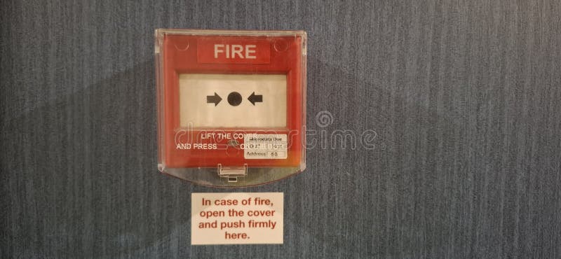 Red Fire Alarm Unit Mounted on Blue Wall with Instruction for Emergency ...