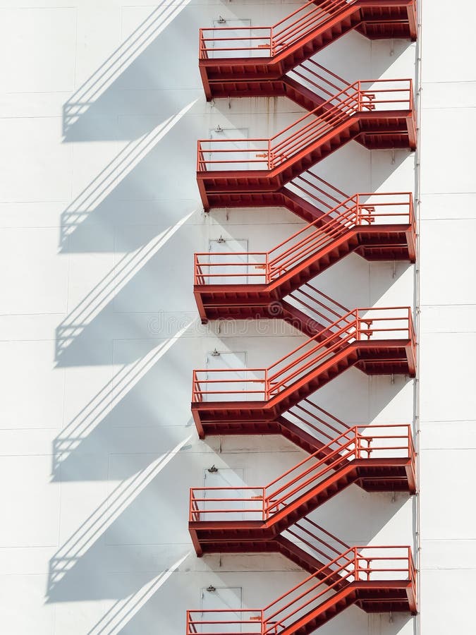 Red Fire Escape Ladders on White Building Stock Image - Image of ...