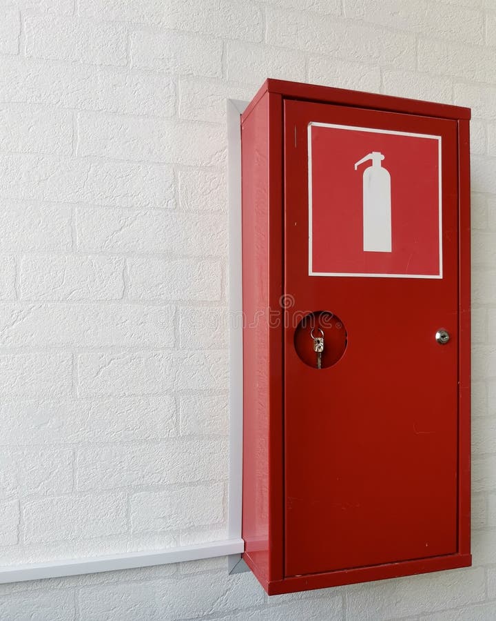 Red Fire Extinguisher Cabinet Mounted on a White Brick Wall. Stock ...
