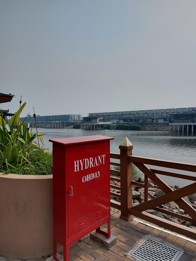 A Red Fire Extinguisher on the Edge of the Wharf Stock Photo - Image of ...