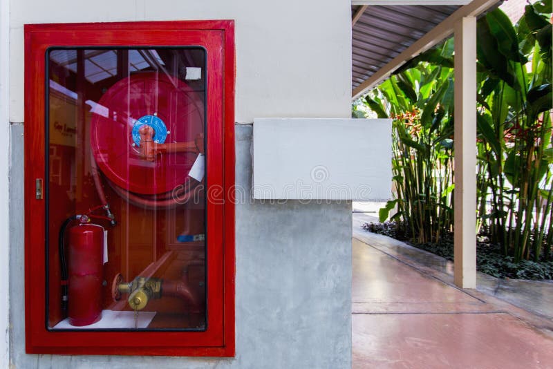 Red fire hose cabinet. stock photo. Image of isolated - 94634750