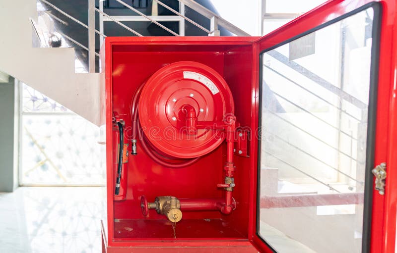 Red Fire Hose Cabinet and a Fire Extinguisher Stock Photo - Image of ...